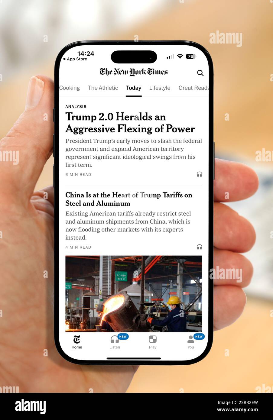 Reading the New York Times on an iPhone 16 Plus Stock Photo - Alamy