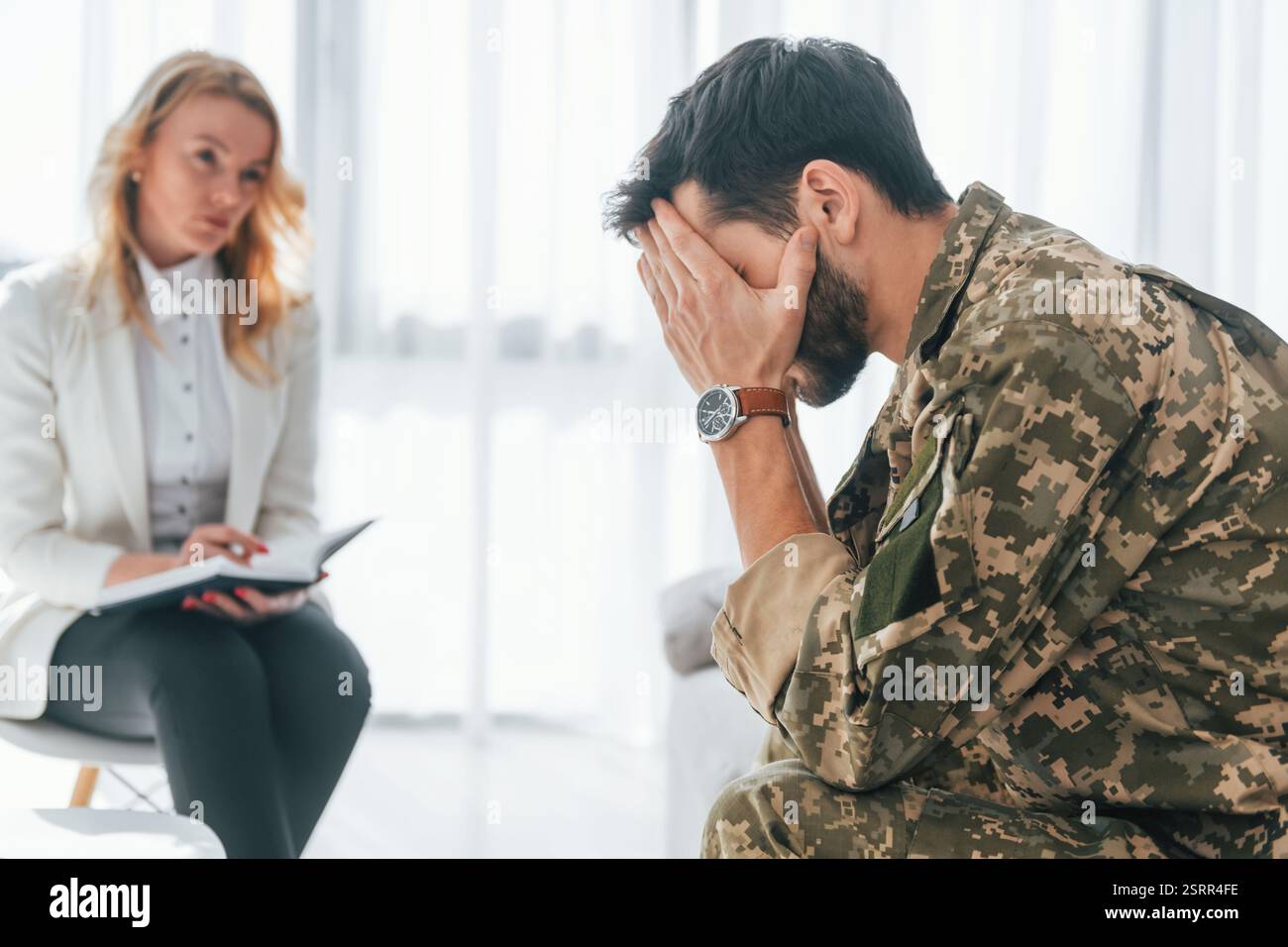 Side view. Soldier have therapy session with psychologist indoors Stock ...