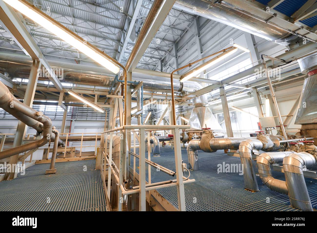 A modern chemical plant featuring extensive pipelines and conveyor ...