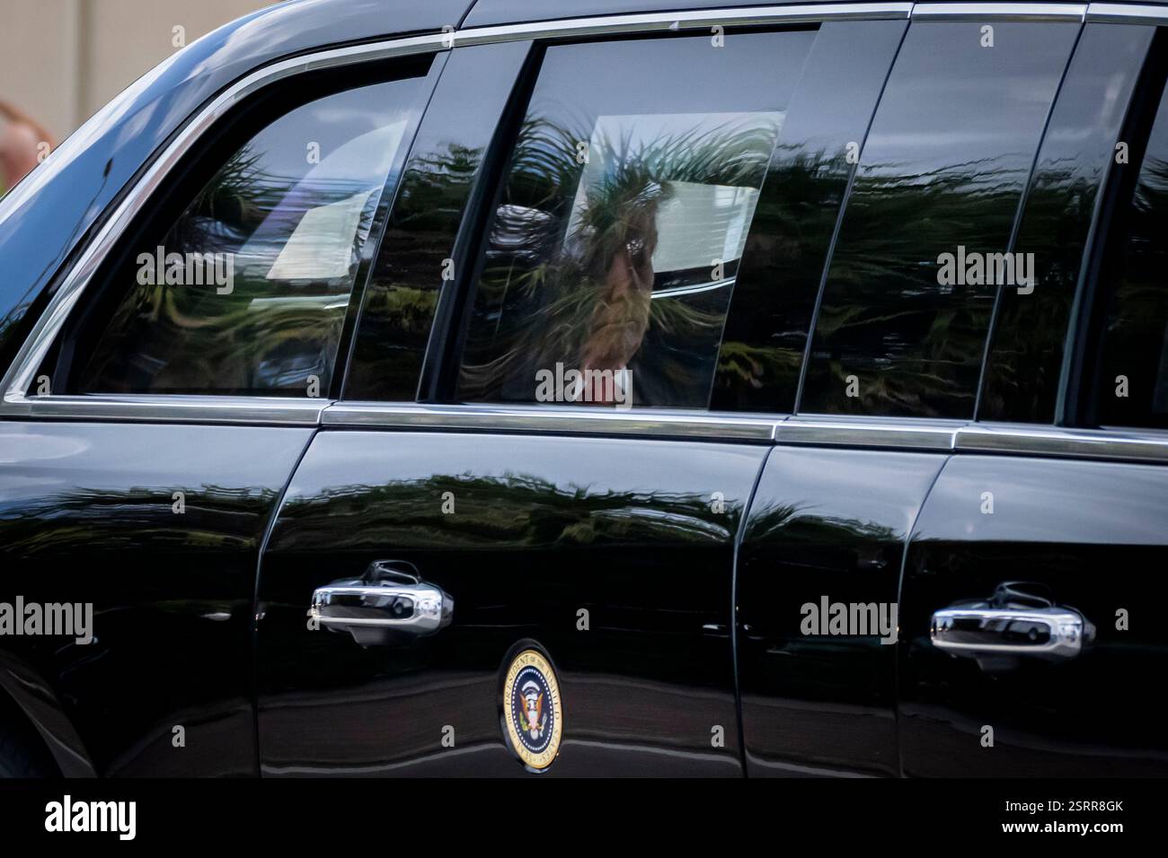 Palm trees are reflected in the windows of President Donald Trump's ...