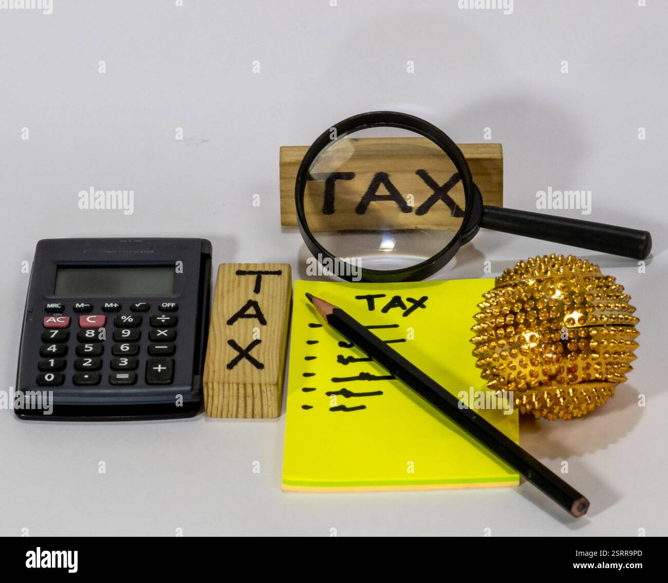 There is a black calculator with red and white buttons, a magnifying ...