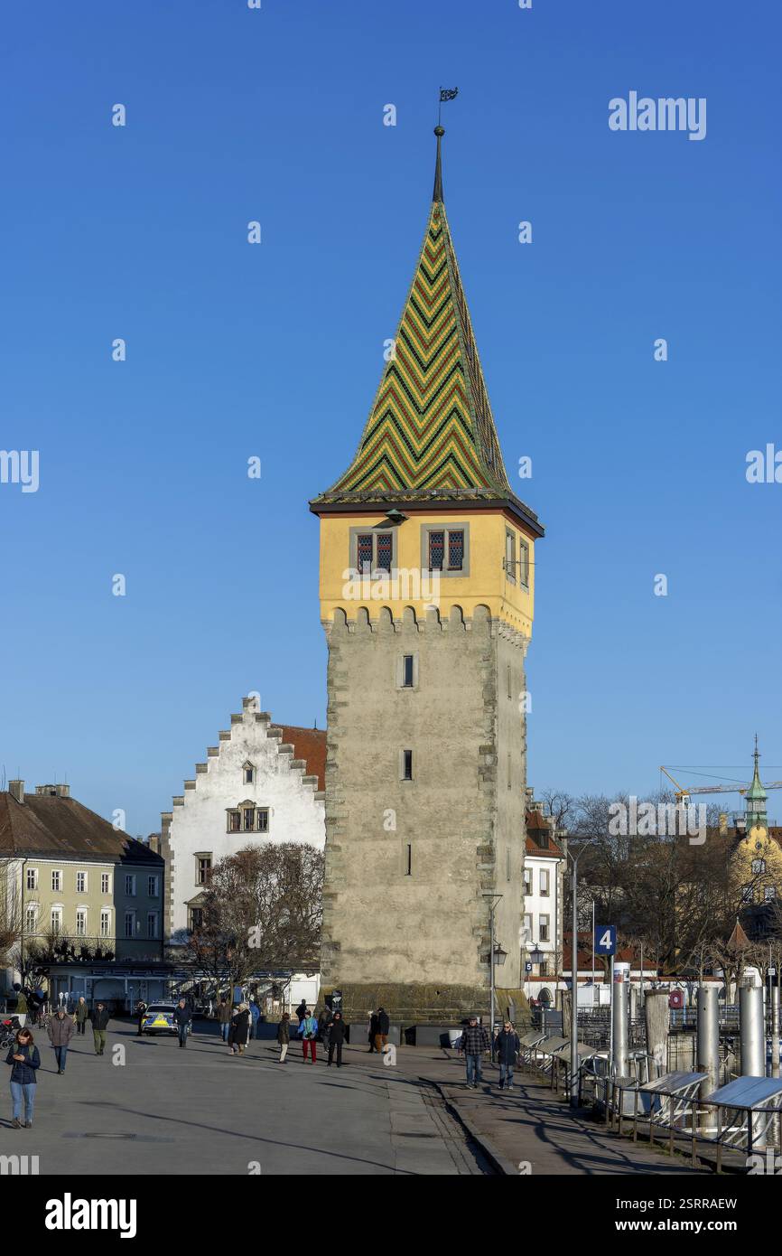 Mang tower with colourful roof tiles and promenade in the harbour, in ...