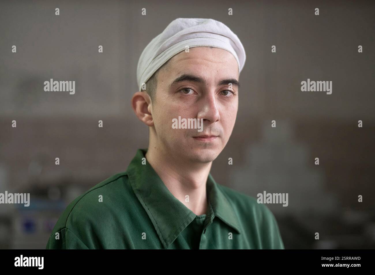A portrait of a Russian soldier working in the prison kitchen. As the ...