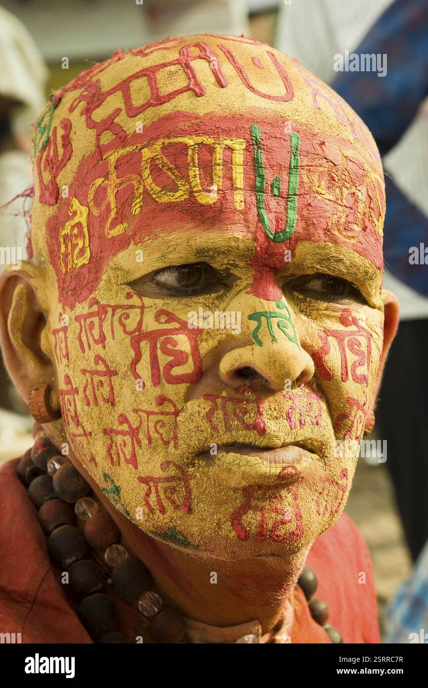Priest writing radhe krishna on face by sandalwood paste, uttar pradesh ...