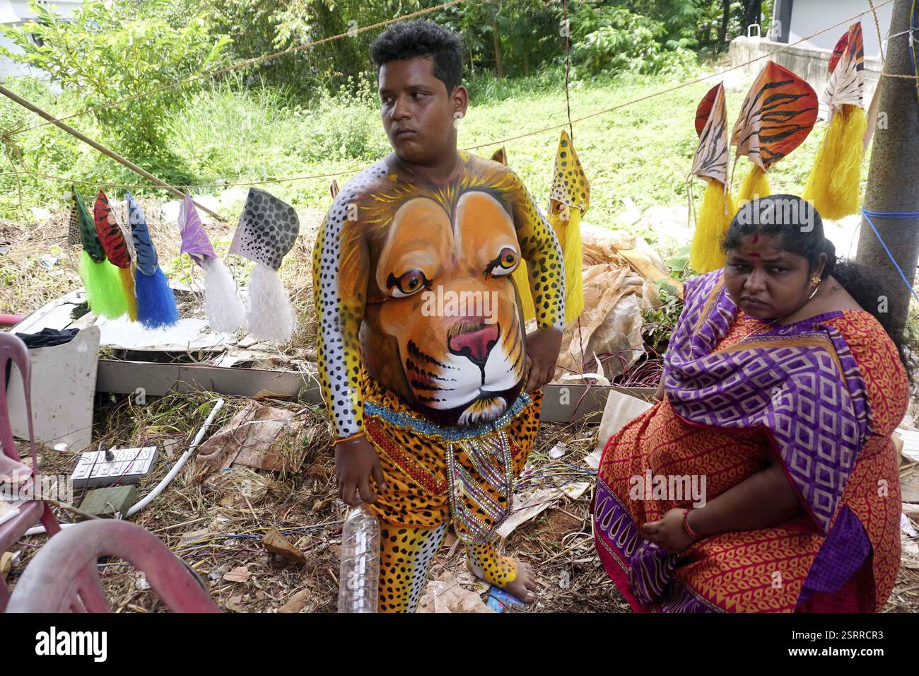 A trained dancer gets his body painted in the colours tiger prepares to ...