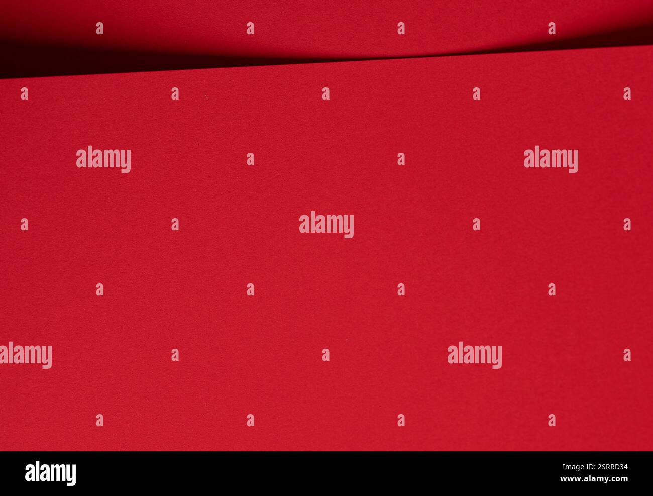 Bold scarlet red paper background with a deep matte texture and ...