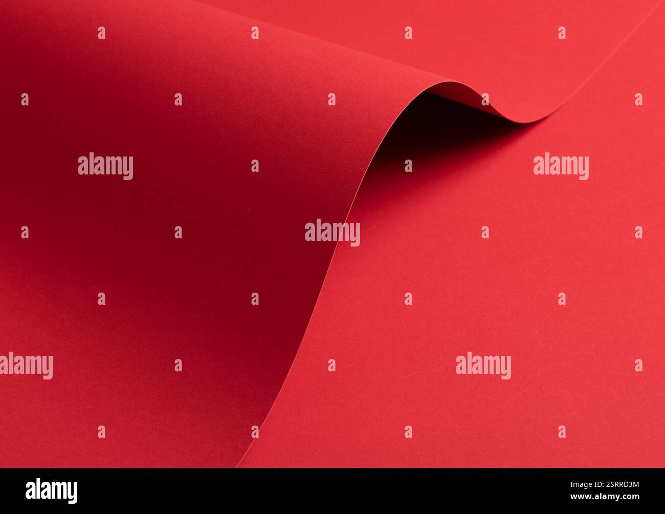 Bold scarlet red paper background with a deep matte texture and ...