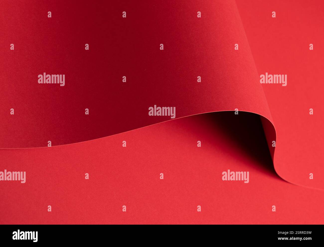 Bold scarlet red paper background with a deep matte texture and ...