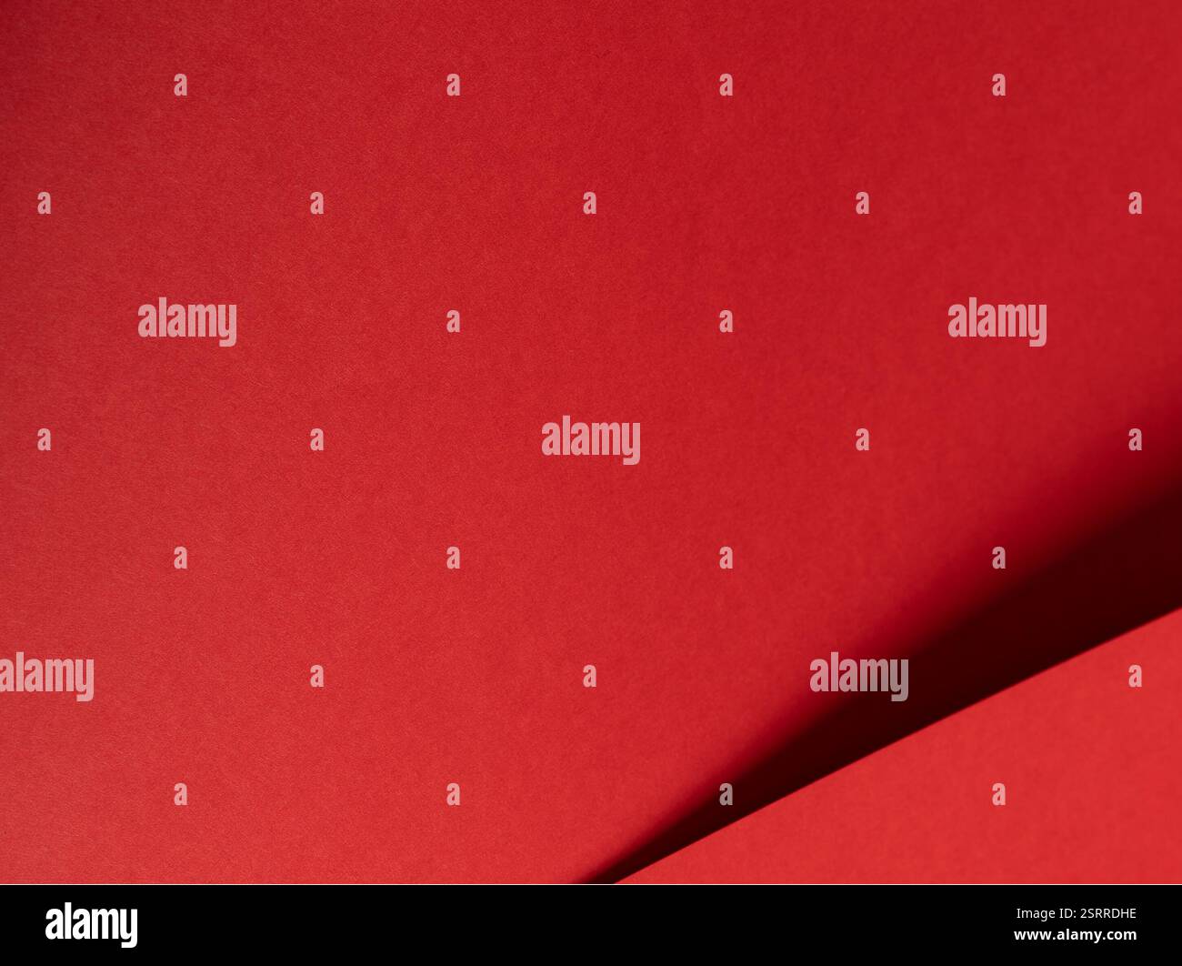 Bold scarlet red paper background with a deep matte texture and ...