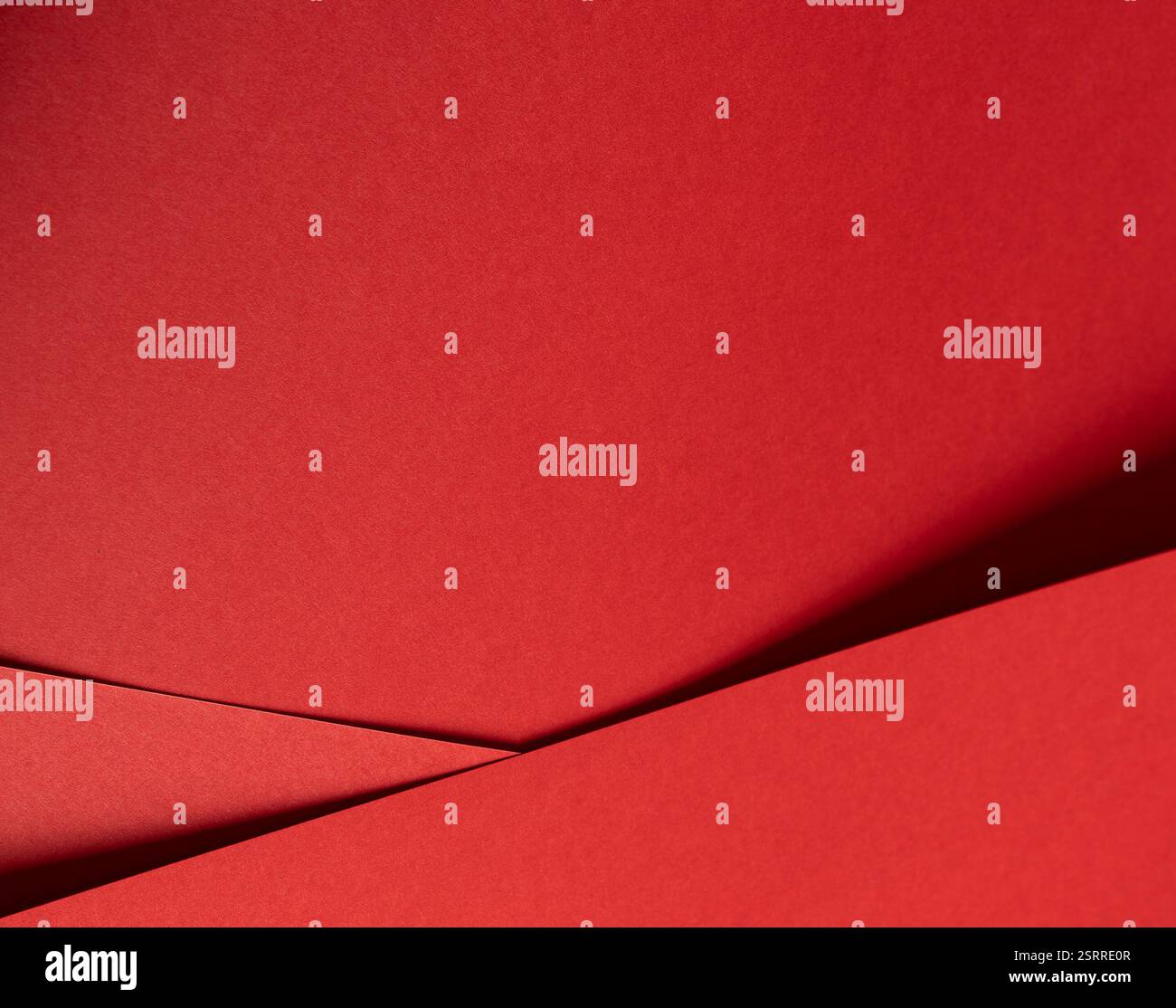 Bold scarlet red paper background with a deep matte texture and ...