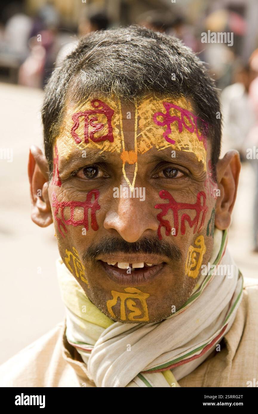 Devotee writing radhe krishna on face by sandalwood paste, uttar ...