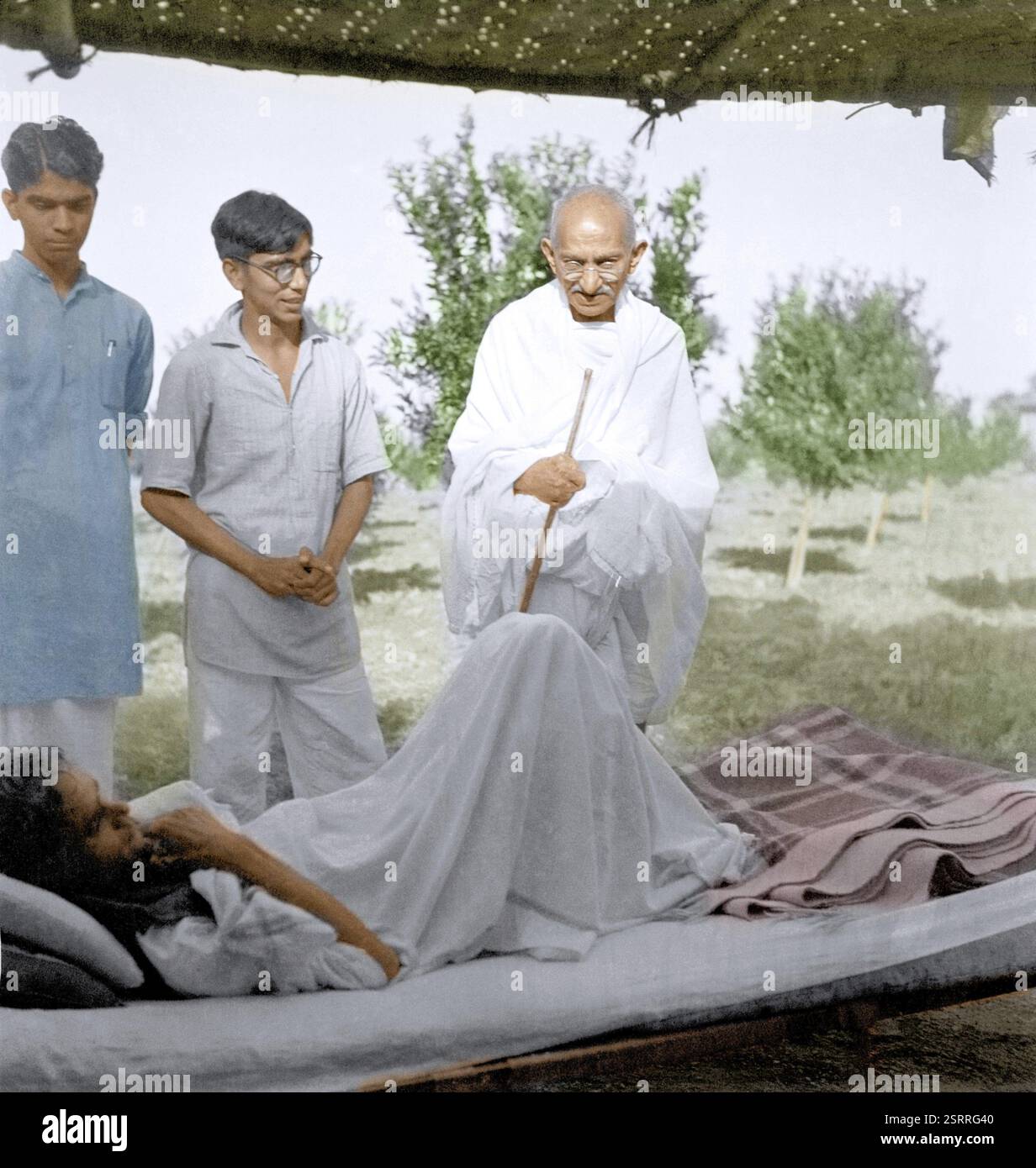 Mahatma Gandhi talking to Kunvarji Parekh resting, Wardha, Maharashtra ...