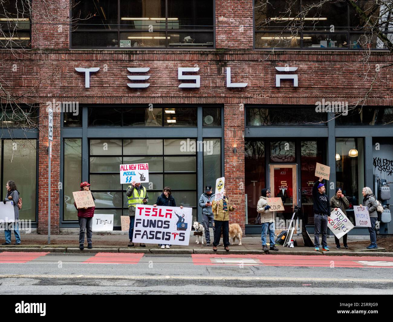 Protesters rally outside the Tesla showroom in downtown Seattle ...