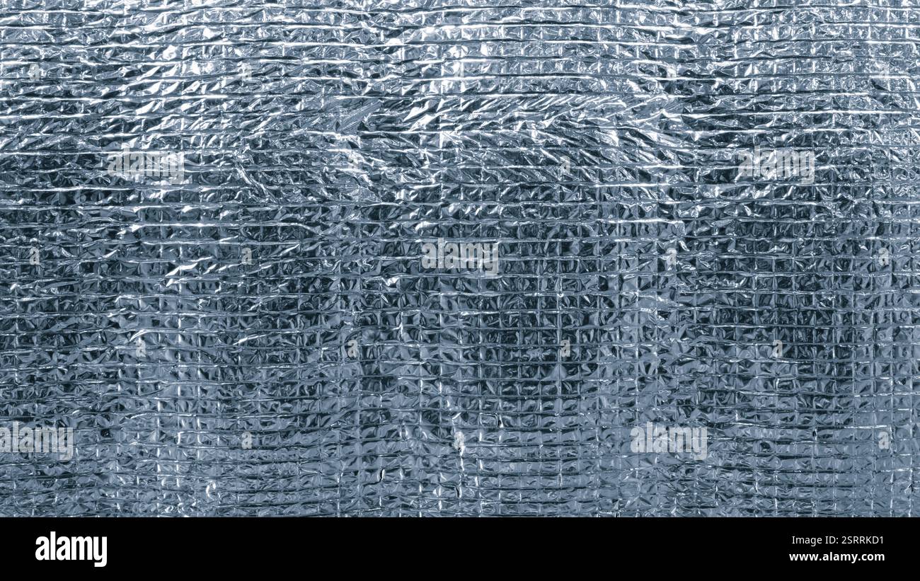 A blue and silver foil with a pattern of squares. The foil is shiny and ...