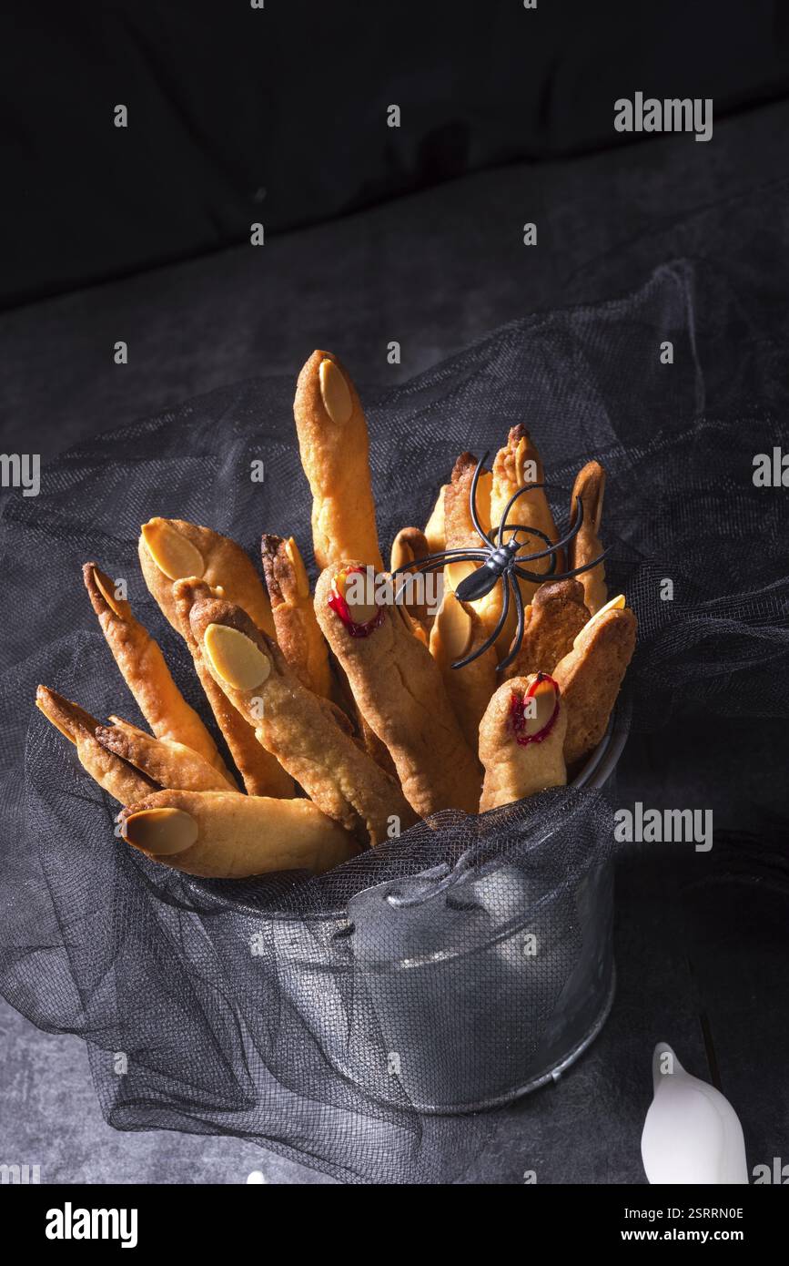 Halloween biscuit finger and cake coffin Stock Photo - Alamy