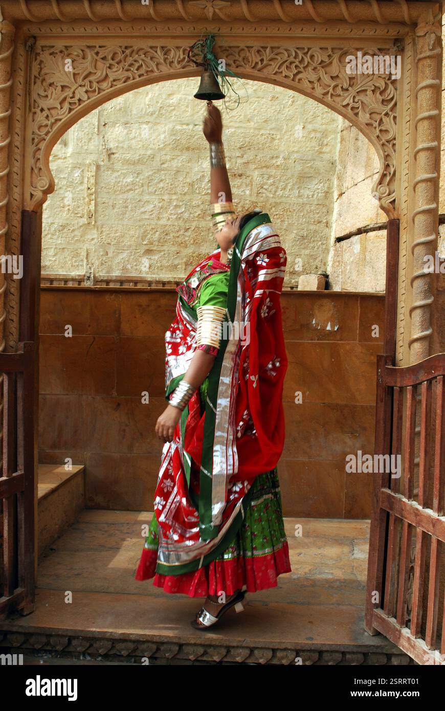 Rajasthani marwari lady in raika community dress ringing temple bell ...