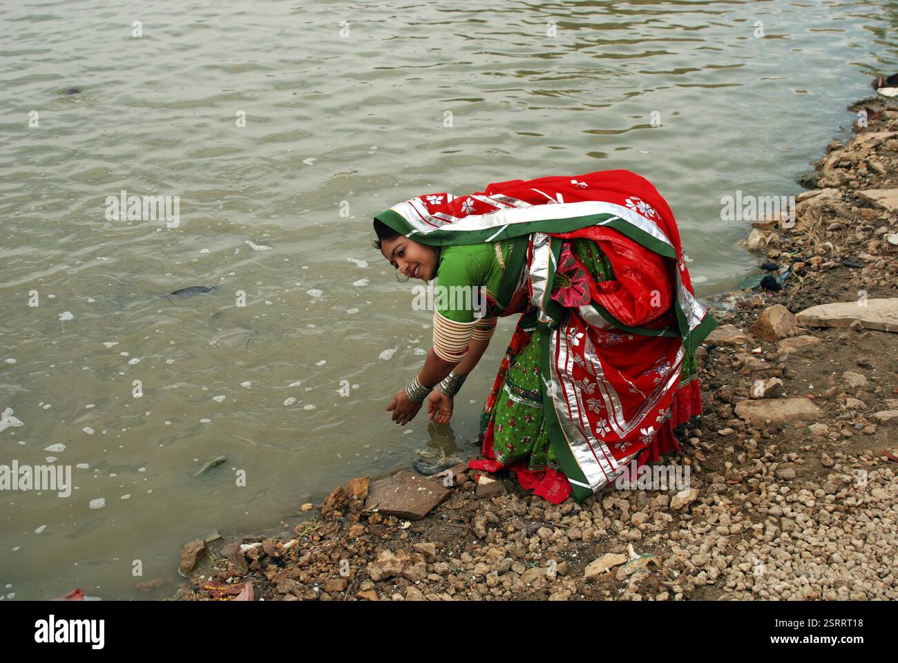 Rajasthani marwari lady in raika community dress washing hand in ...