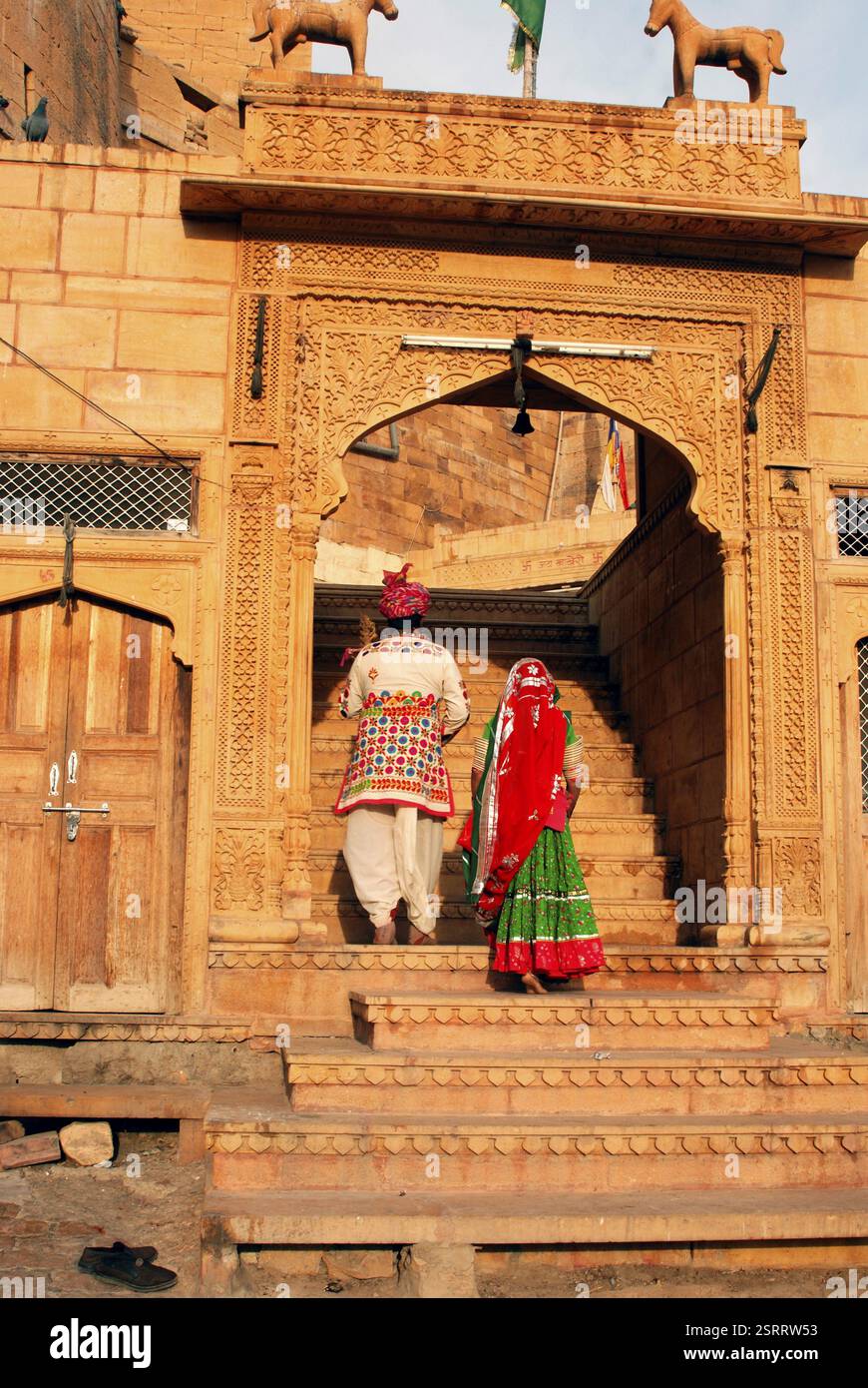 Folk musician and lady on steps of Baba Ramdeo temple in Jaisalmer ...