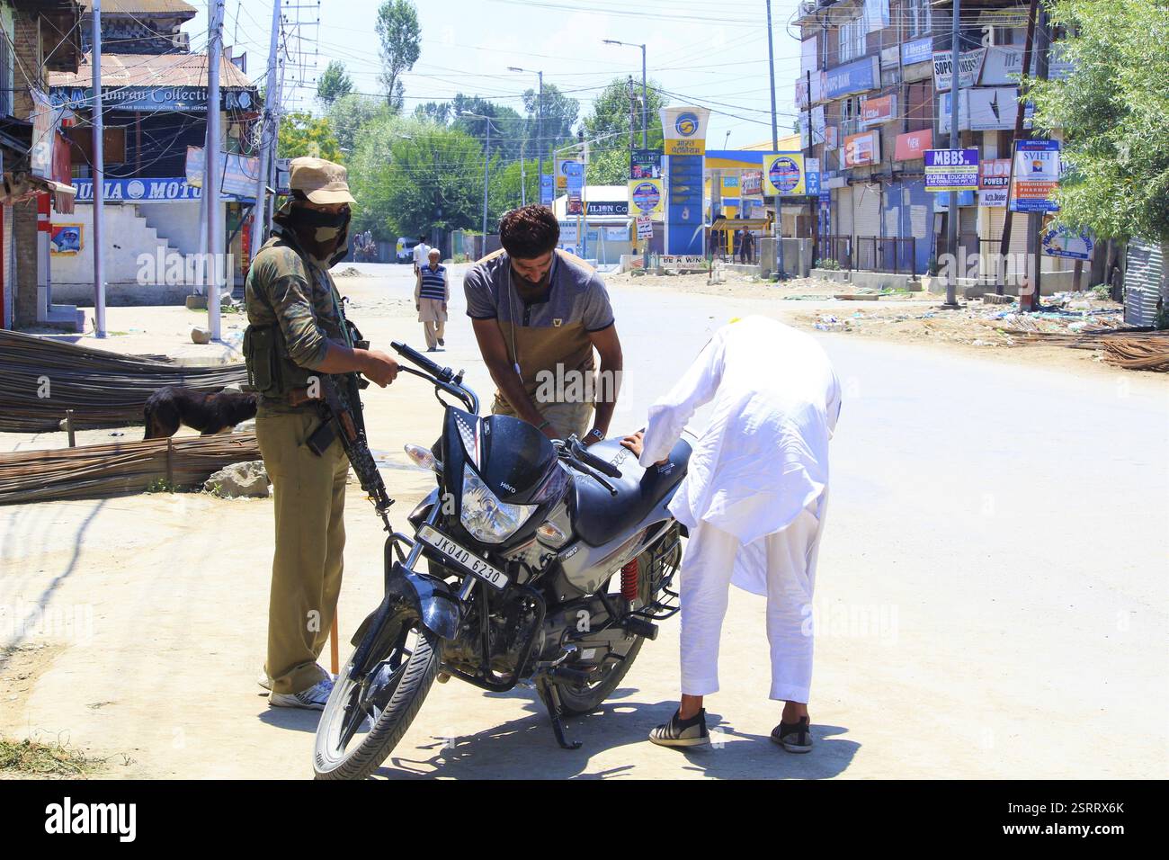 Policeman checking bike during death anniversary of Hizbul Mujahideen ...
