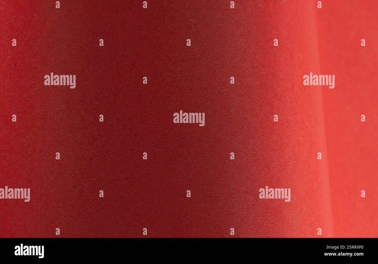 Deep carmine paper background with a velvety matte texture and subtle ...