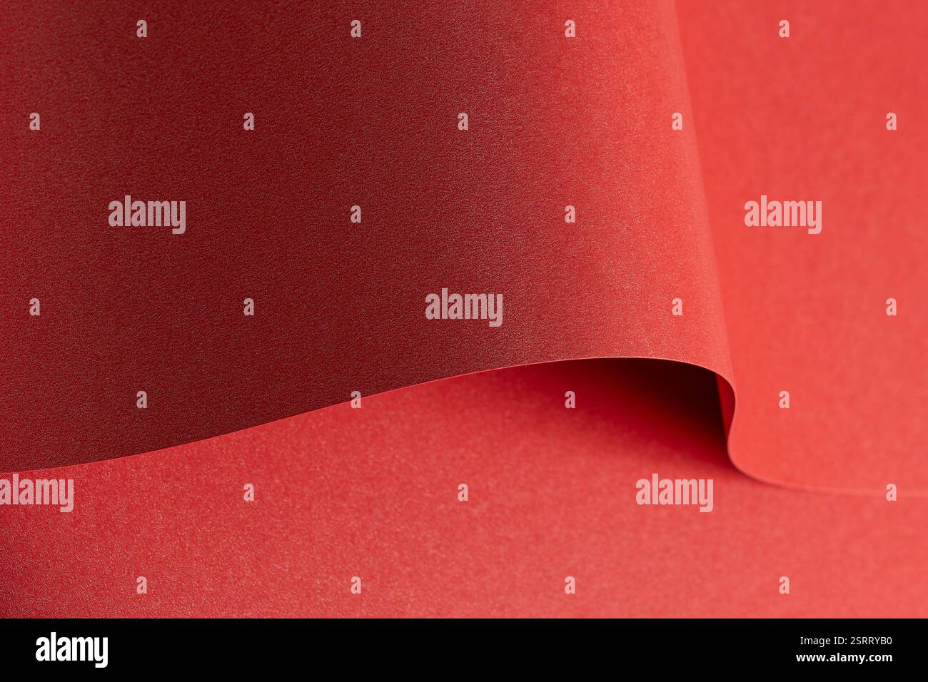 Deep crimson paper background with a velvety matte texture and subtle ...