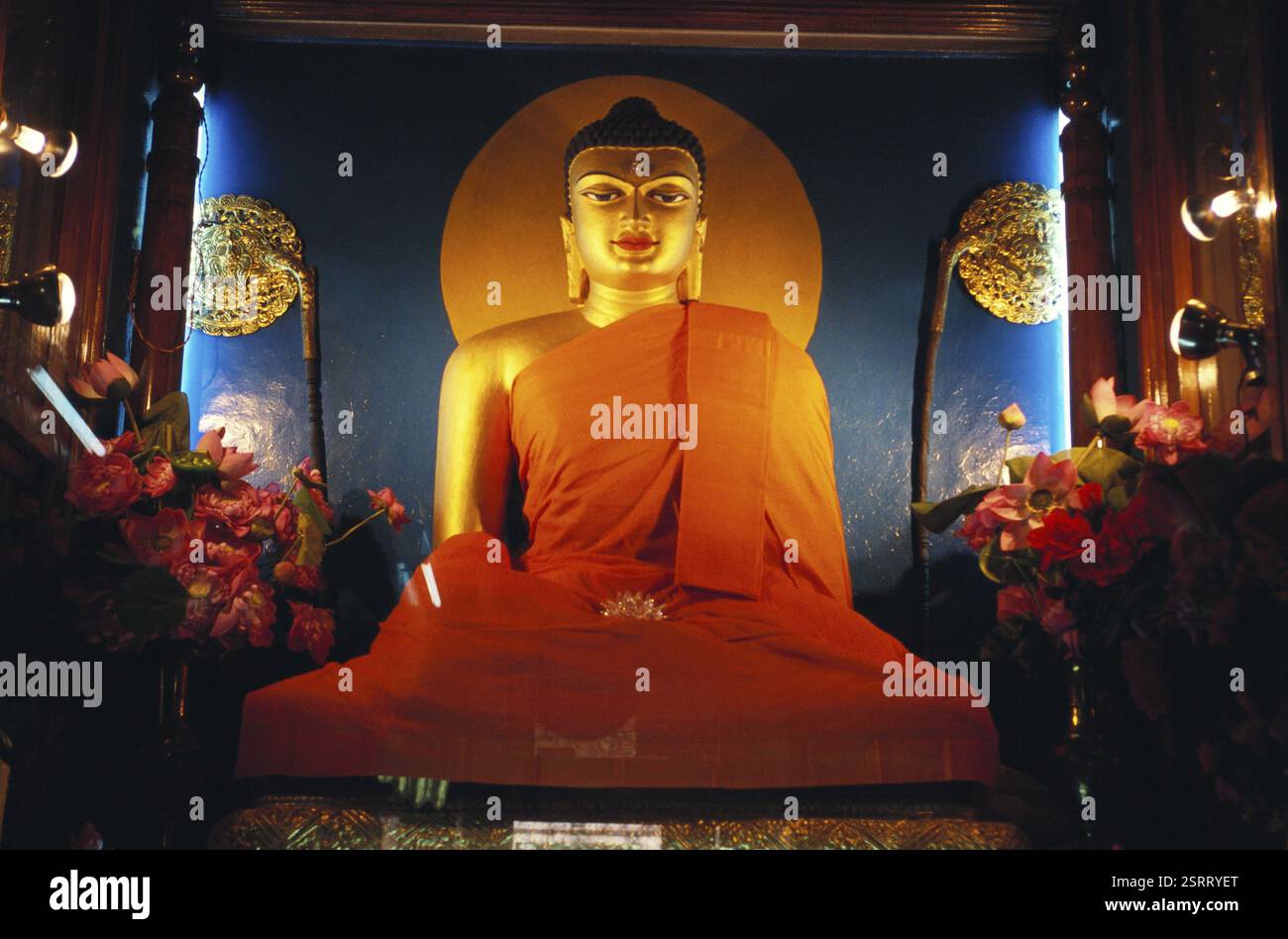 Huge gilded Buddha his hands touching earth inside Mahabodhi temple ...