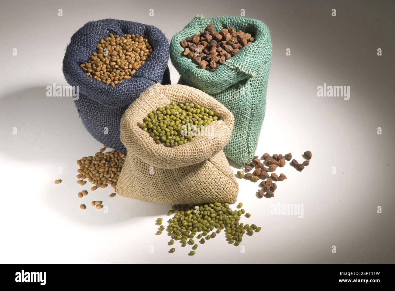 Black gram, kidney bean, green grams in jute sack spread on white ...