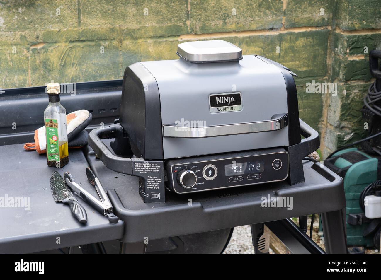 Electric powered outdoor oven by Ninja Woodfire cooking chicken, UK ...