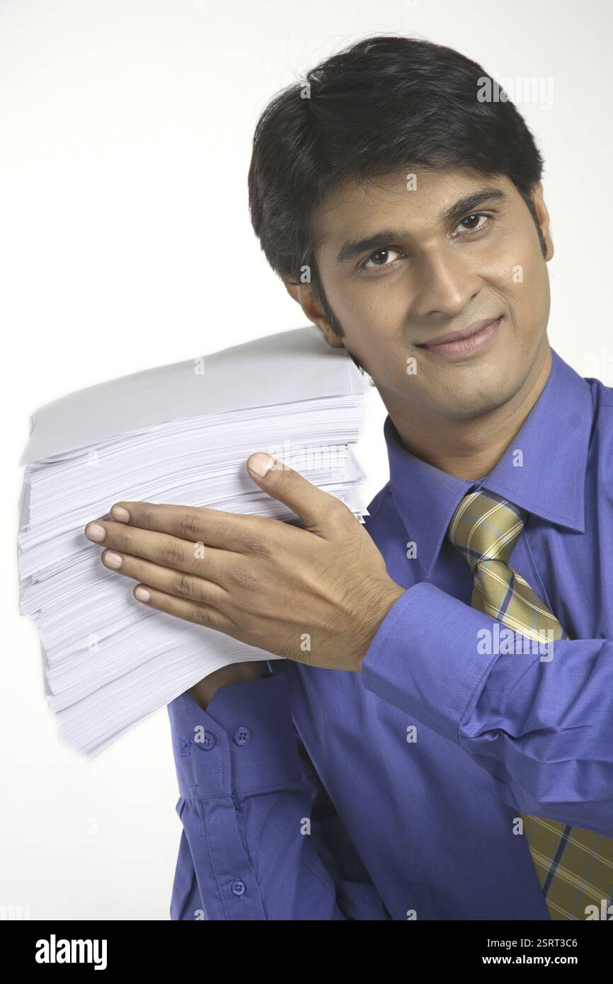 Executive holding bundle of papers on shoulder MR#687M Stock Photo - Alamy