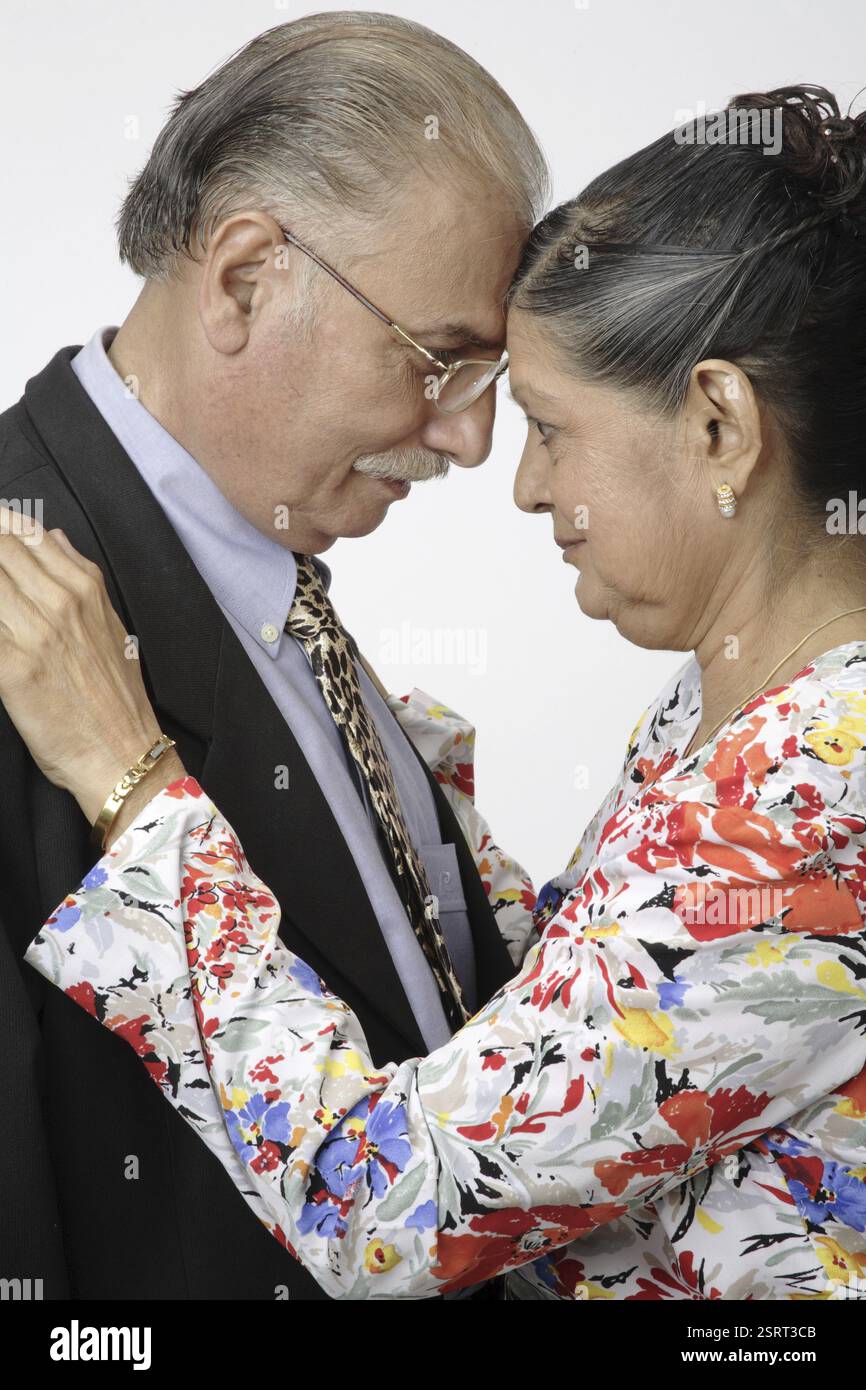 Old couple, old woman touching forehead on old man concerned look MR ...