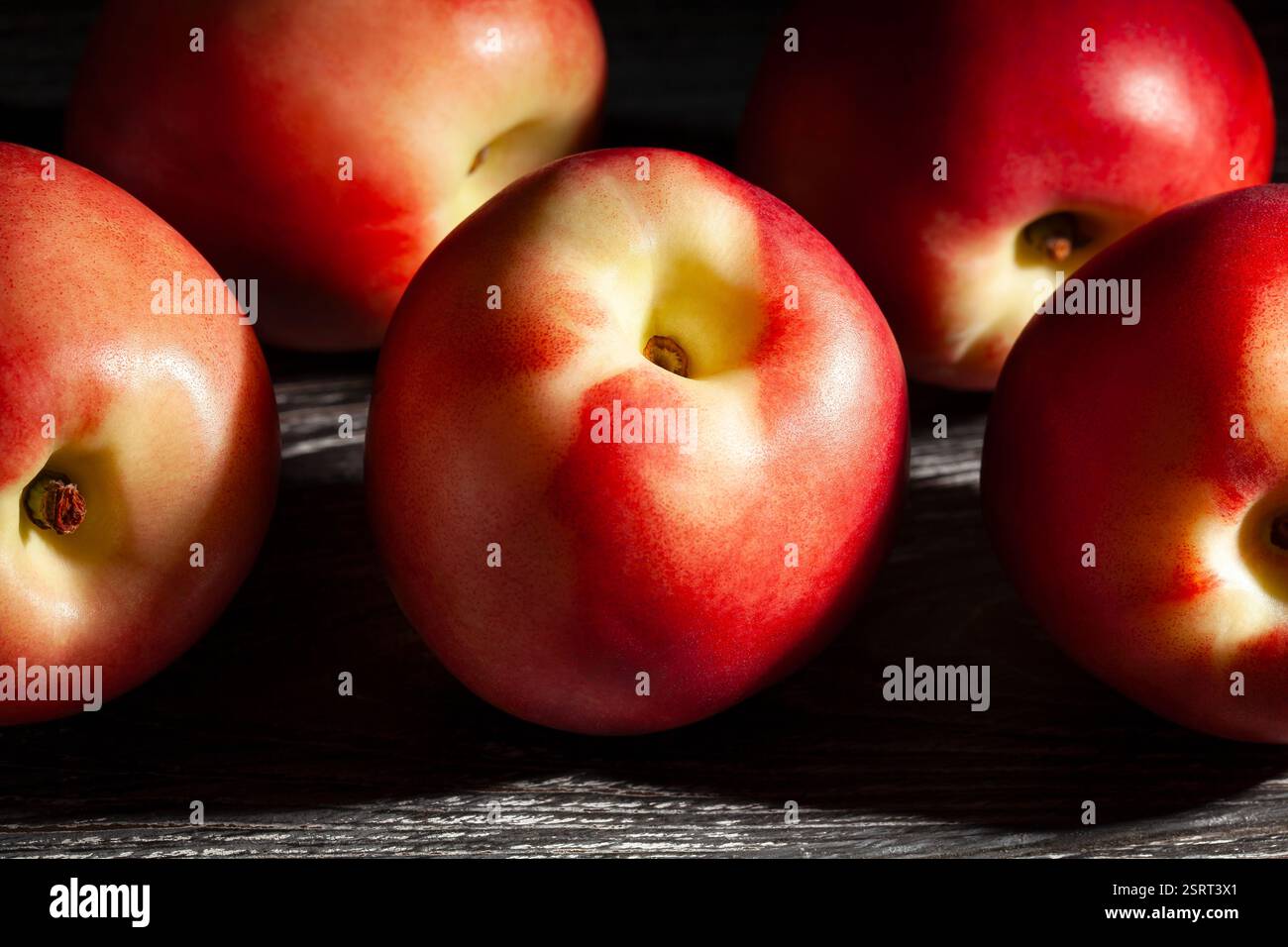 white nectarine on black wood background Stock Photo - Alamy