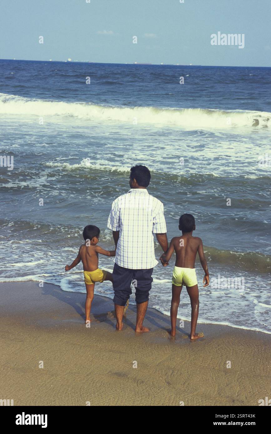 Father & two sons enjoying in sea marina beach, bay of bengal, Chennai ...