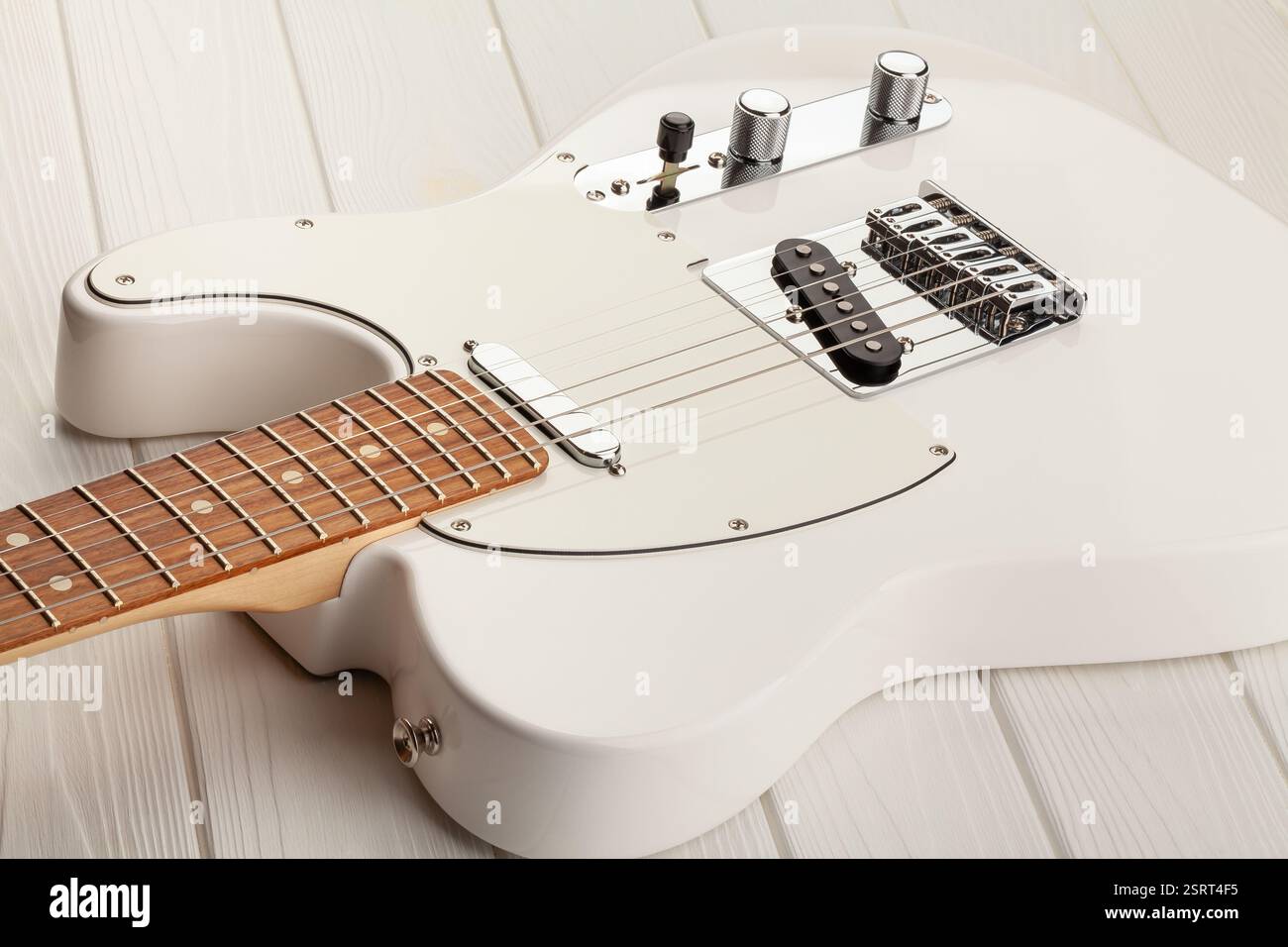 white electric guitar on wood background Stock Photo - Alamy