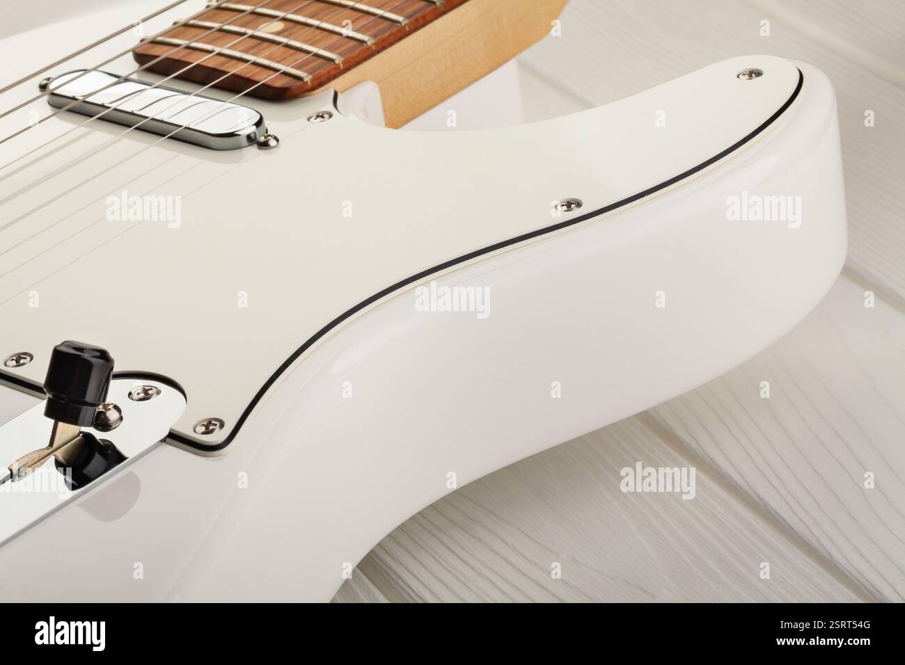 white electric guitar on wood background Stock Photo - Alamy