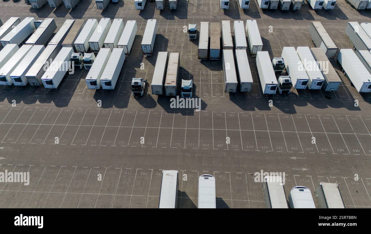 Aerial view of a large parking lot filled with numerous parked semi ...