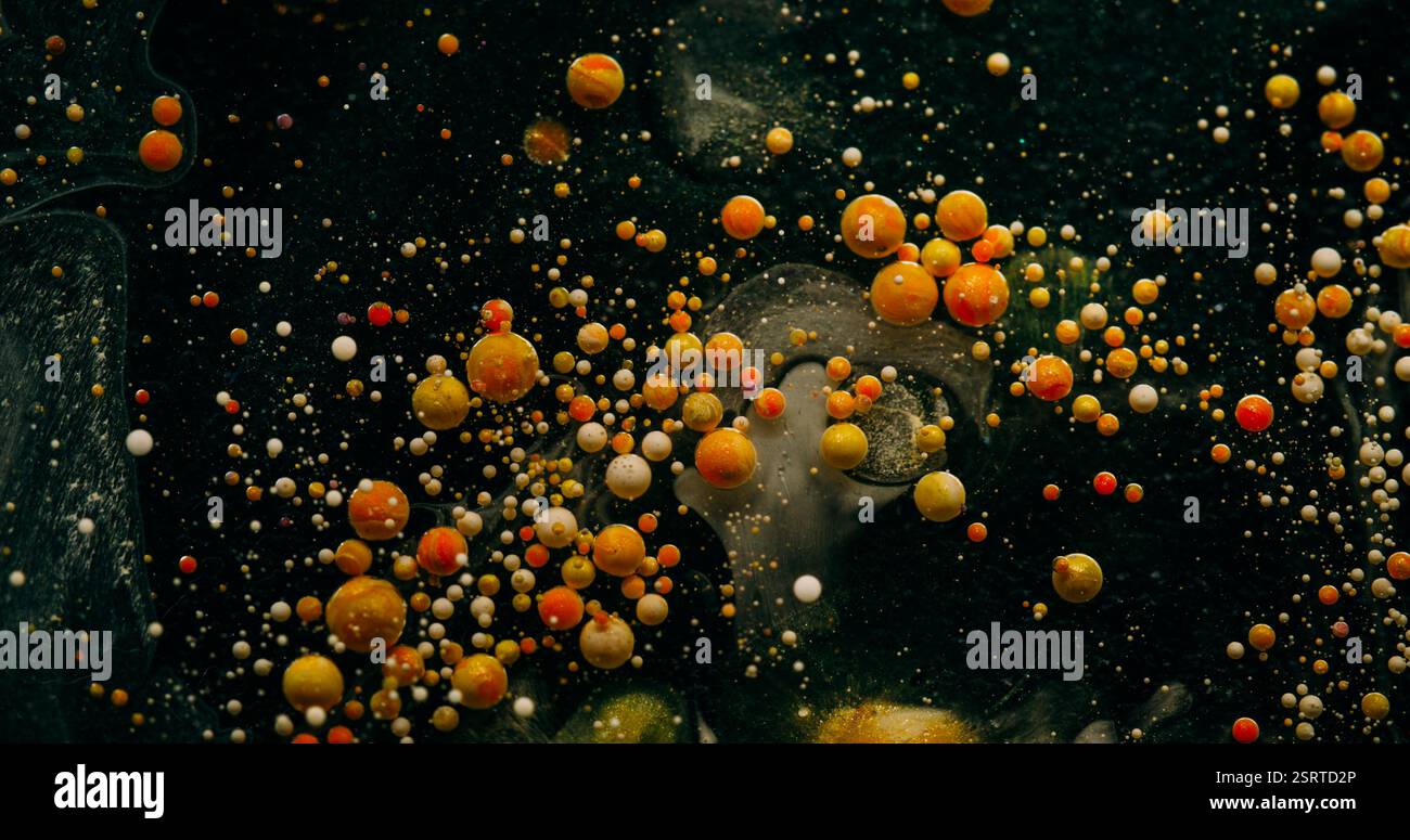 Bubble flow. Paint blob. Colorful drops particles spilling in black ...