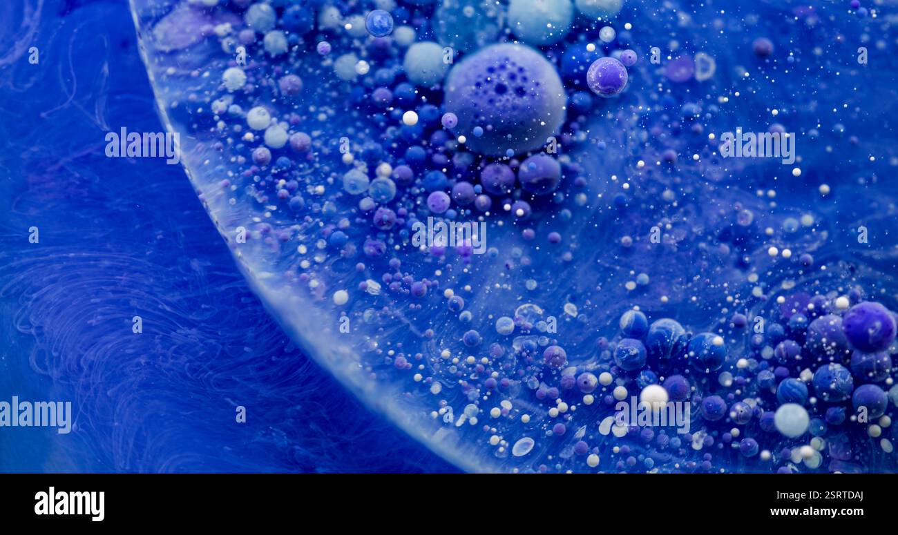 Multicolored emulsion. Oil bubbles. Blue violet liquid texture mixing ...
