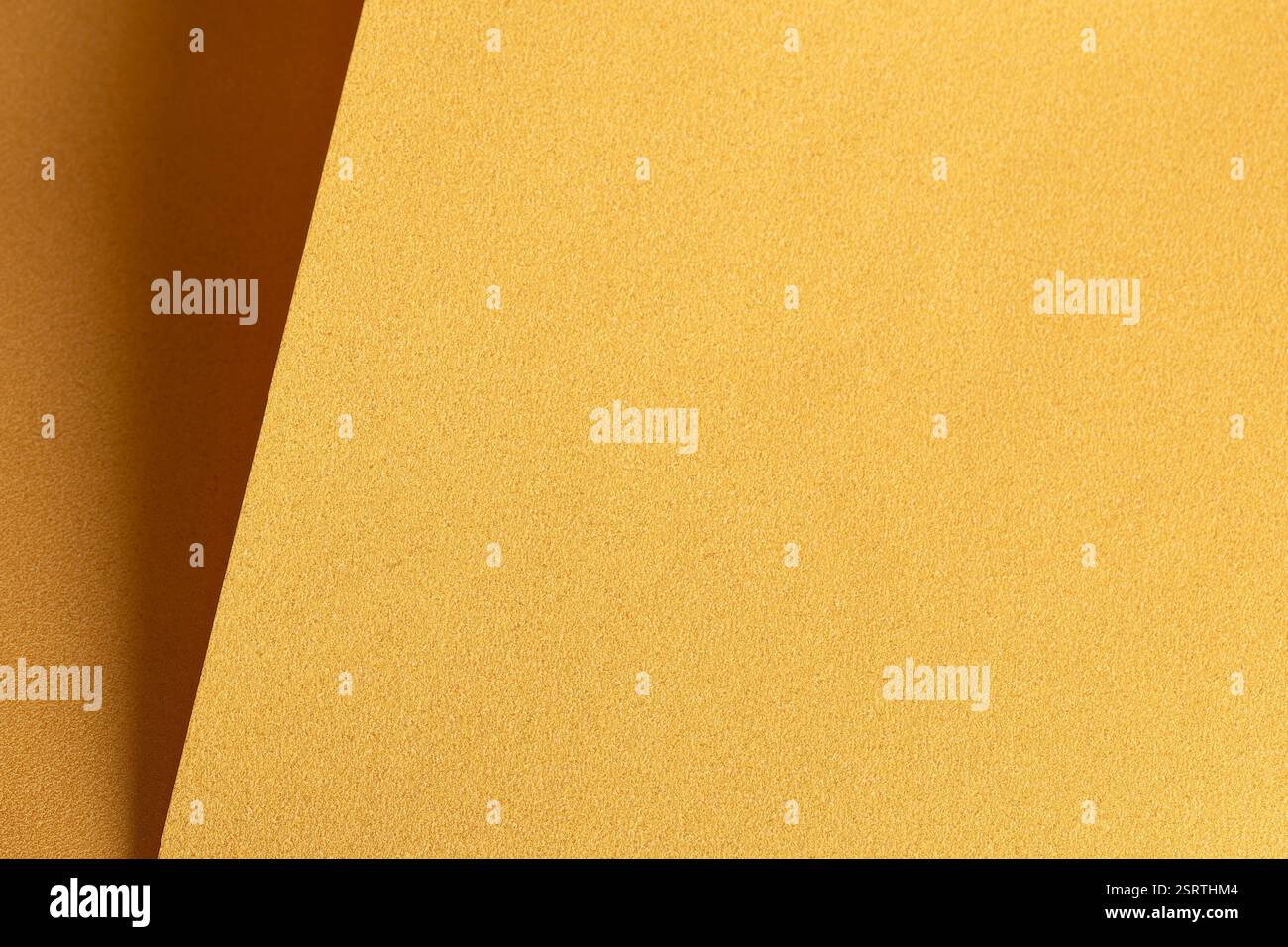 Golden saffron paper background with deep mustard and ochre tones ...