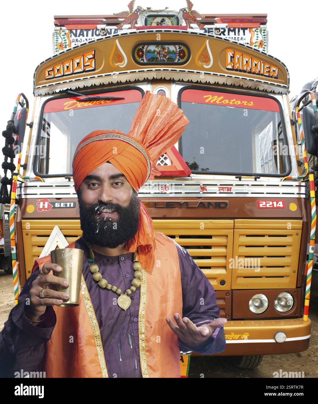 Sikh man holding glass of lassi standing in front of lorry MR#779C ...