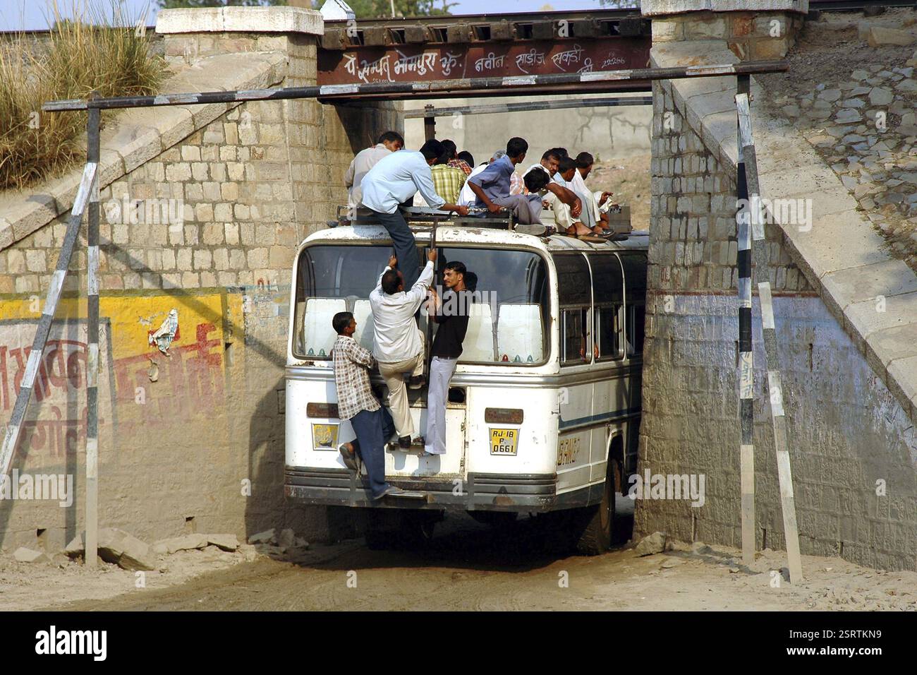 A crowded bus is passing through a narrow bridge, Fatehpur Shekhawati ...