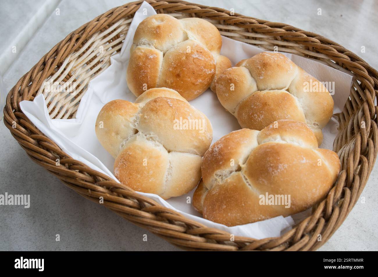 Maltese local bread: small salty buns in i bread basket Stock Photo - Alamy