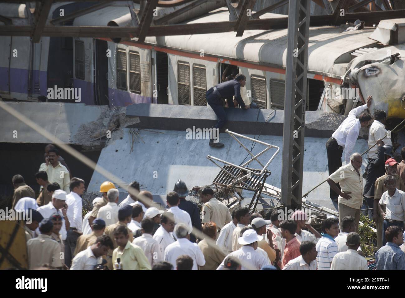 People gather during water pipeline collapsed over moving train, thane ...