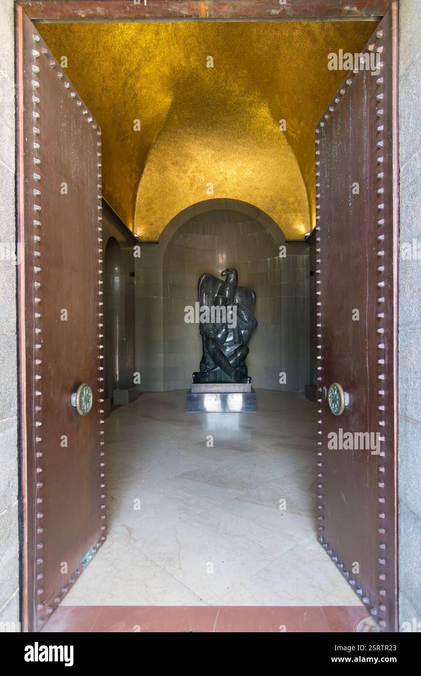 Elegant indoor space featuring a grand statue under a stunning golden ...