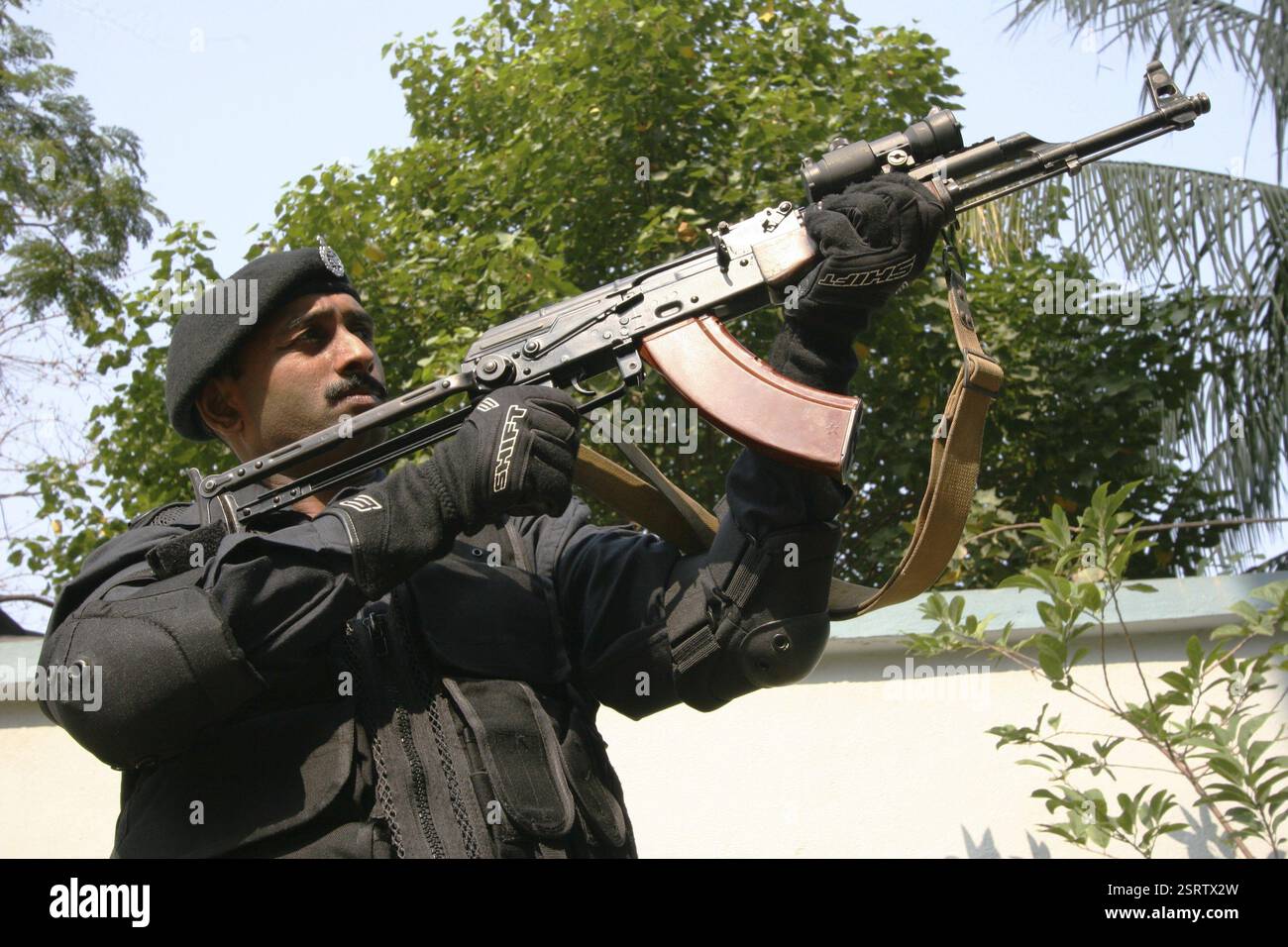 Black Cat commando with an AK 47 light machine gun MR Stock Photo - Alamy