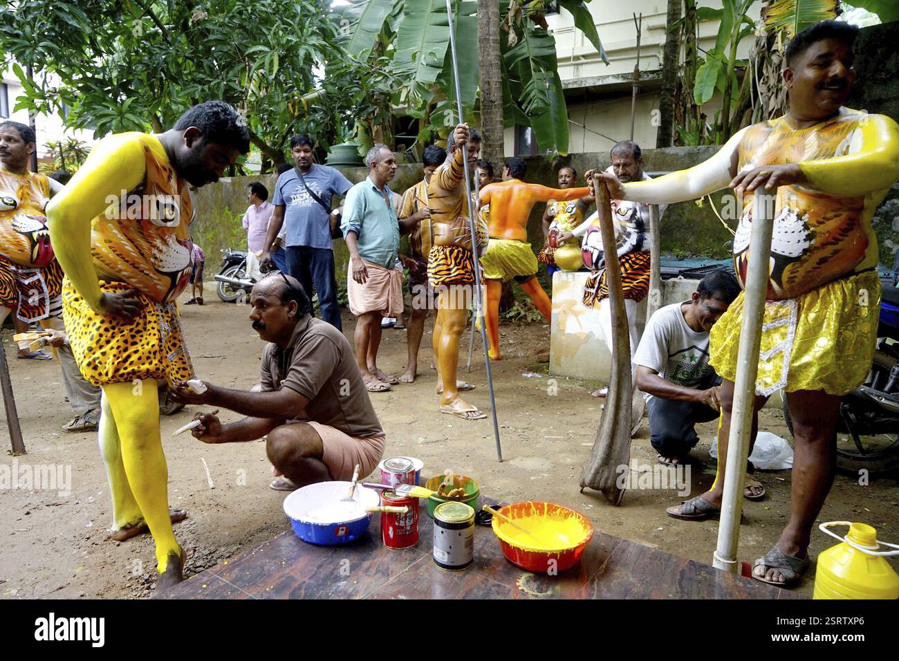 Trained dancers get their body painted in the colours of a tiger ...