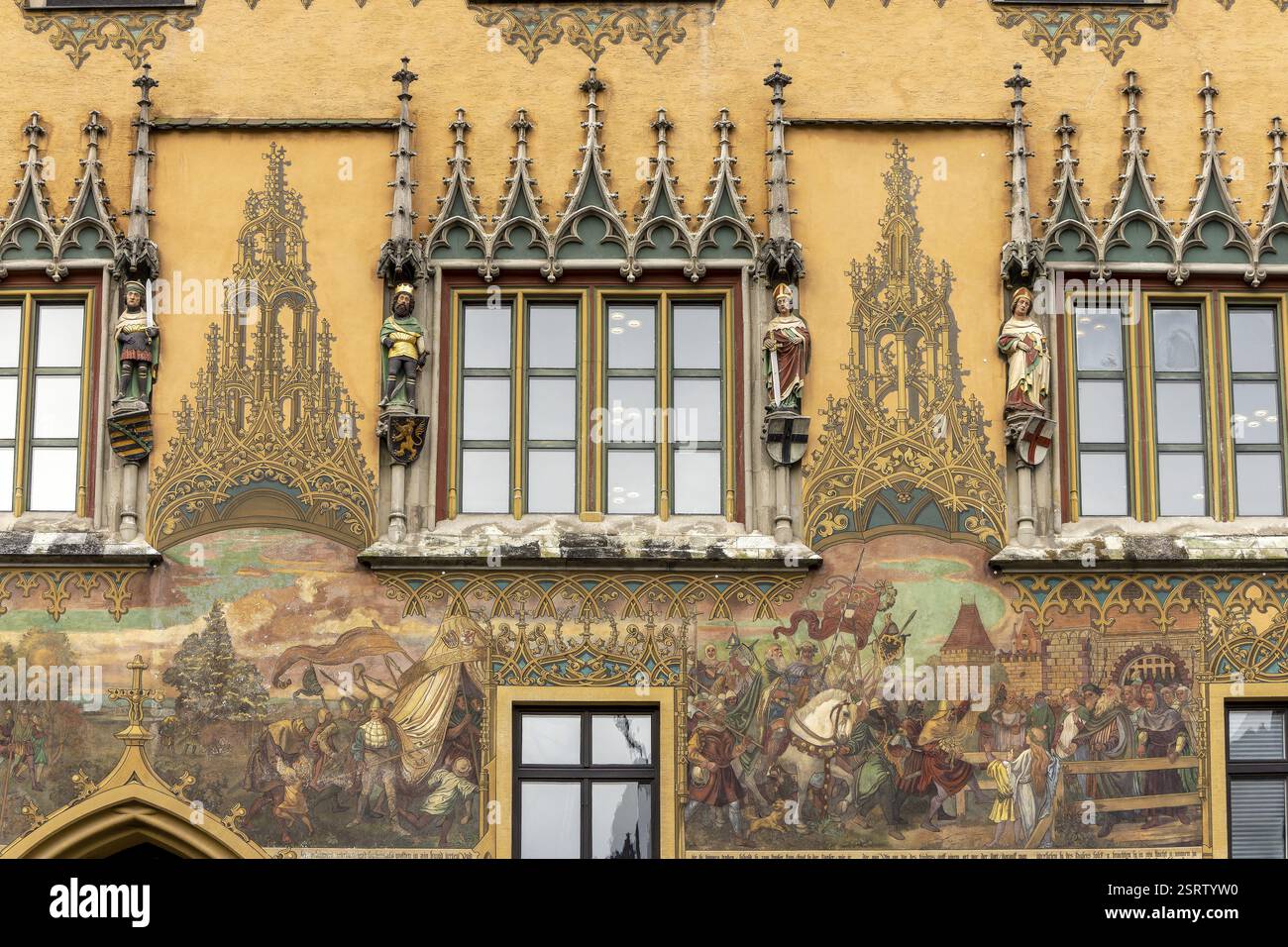 Painted facade and windows with 4 medieval human sculptures on Ulm Town ...