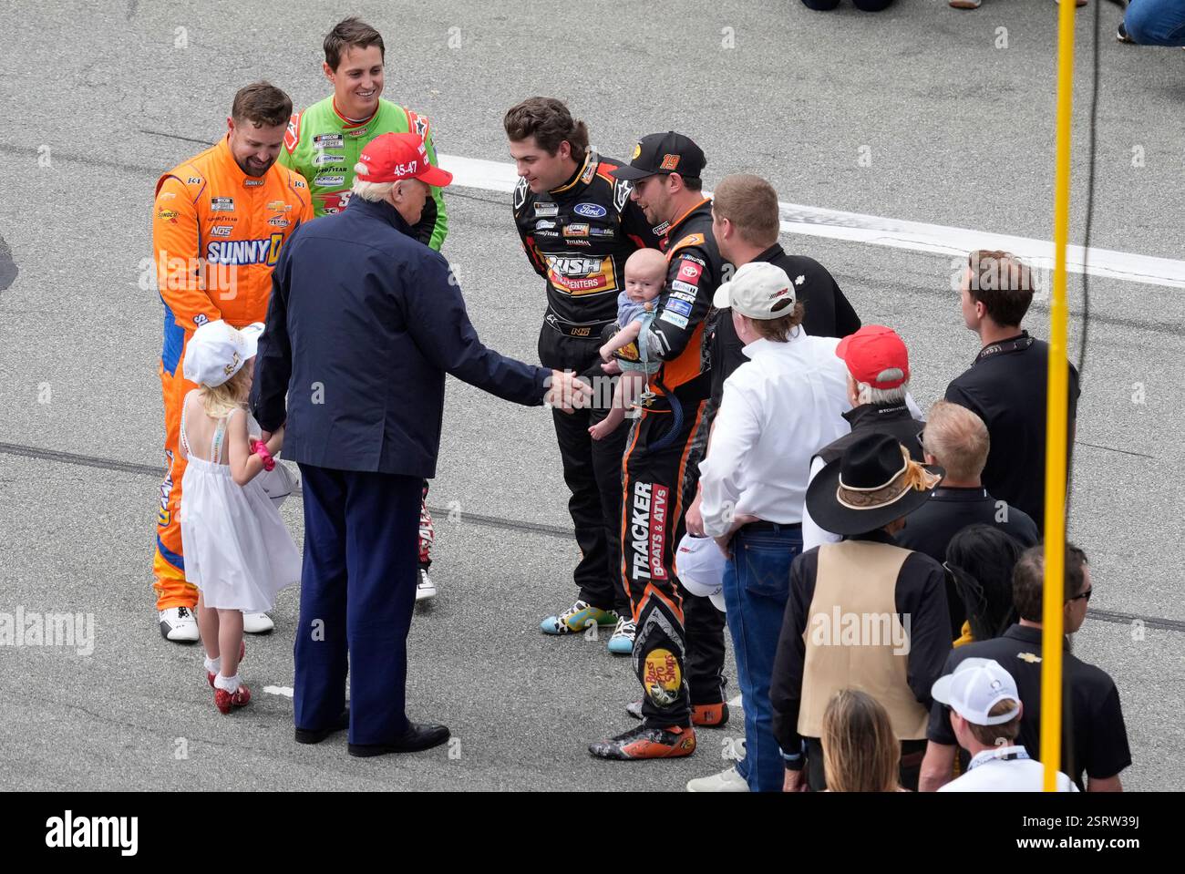 President Donald Trump, with granddaughter Carolina, greets drivers at ...