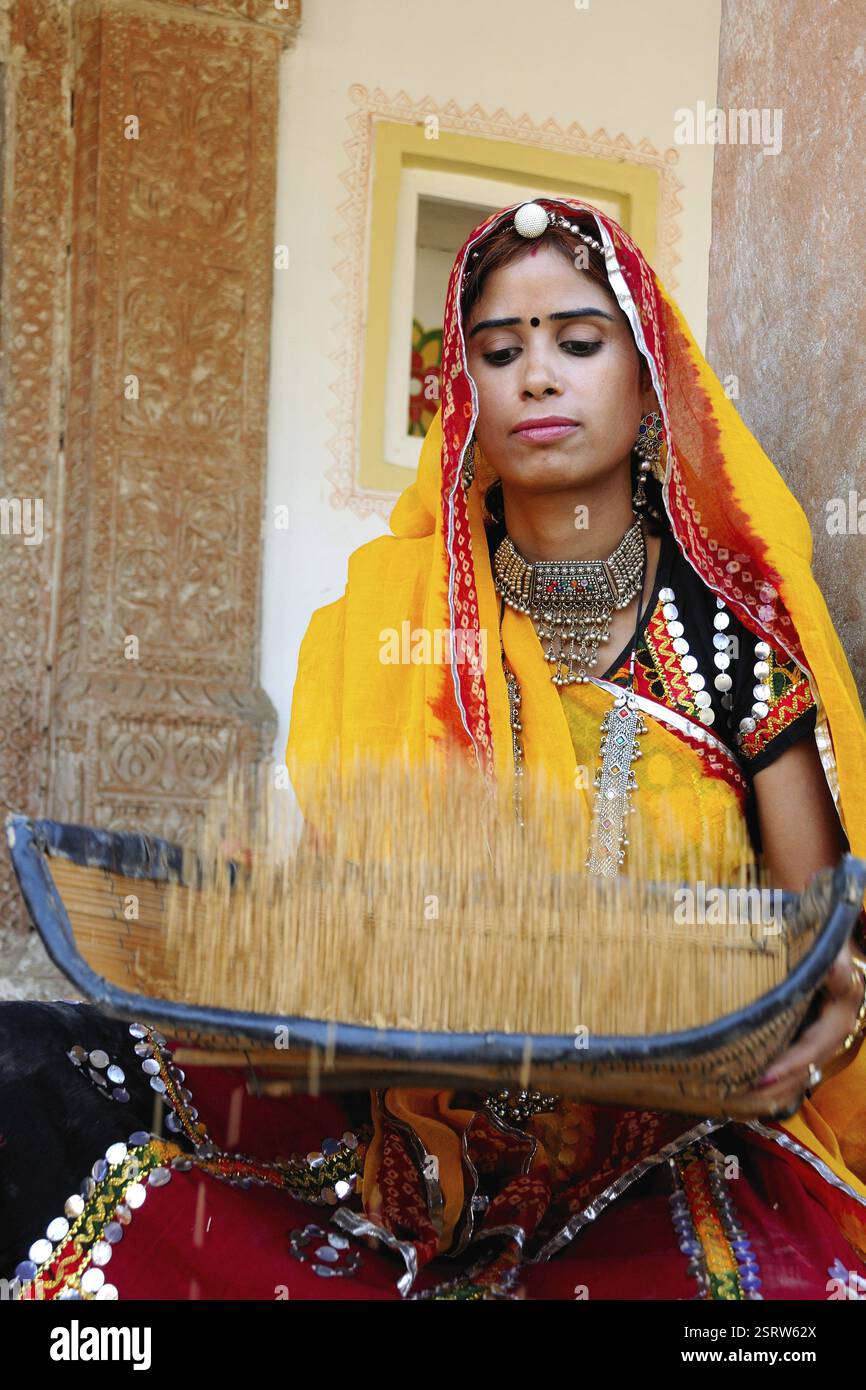 Rajasthani lady sieving wheat grain, Rajasthan, India MR#769C Stock ...