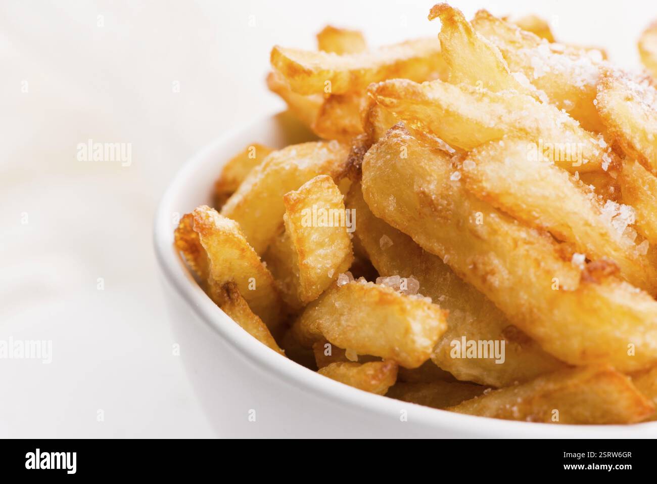 Bowl of potatoe fries on a white background Stock Photo - Alamy