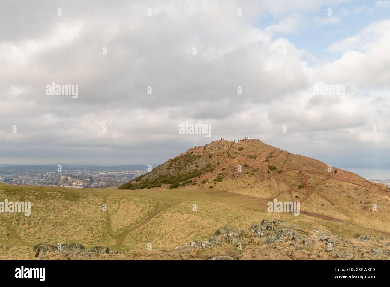 A crowded summit at Arthur’s Seat, where hikers and tourists gather to ...